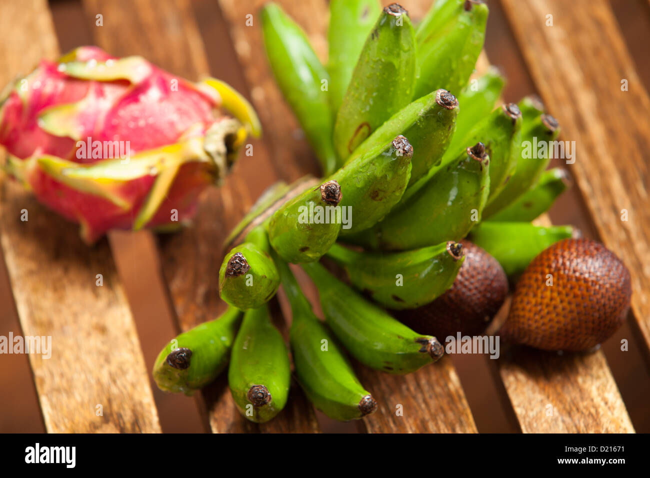 Display of tropical fruit on wooden table in natural light Stock Photo ...