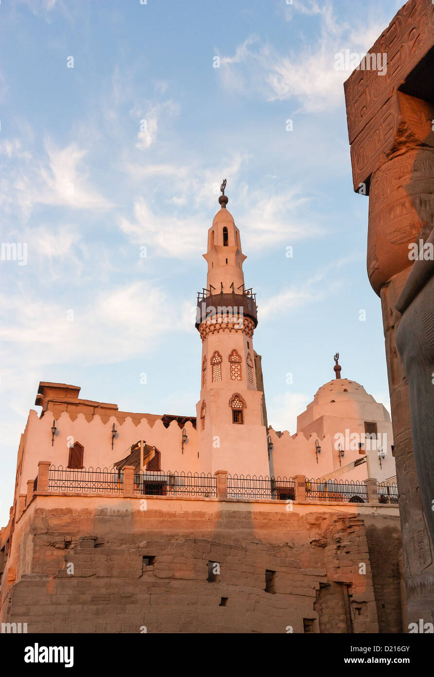 A Mosque inside the Luxor temple illuminated red by the setting sun ...