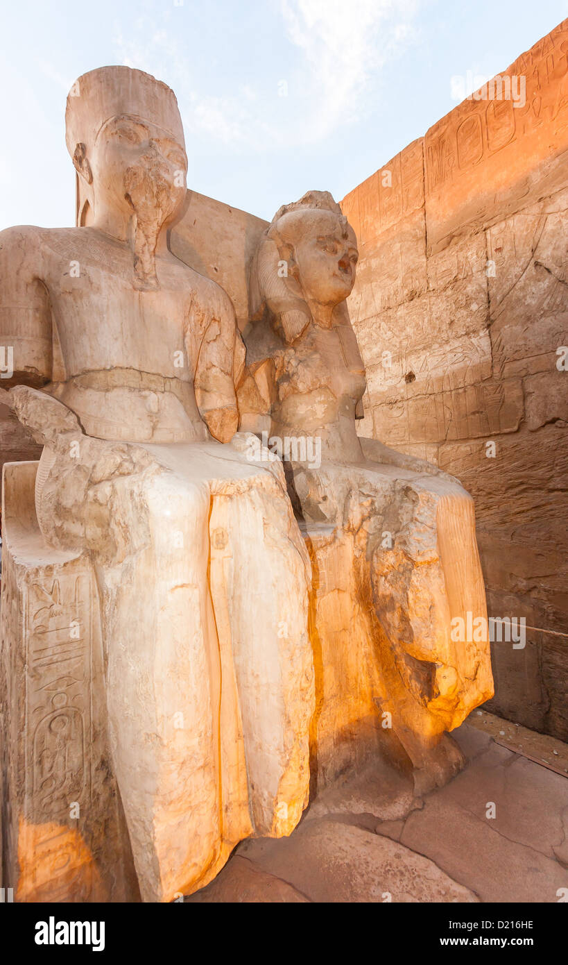 Ancient Egyptian statues lit by artificial light in the early evening ...