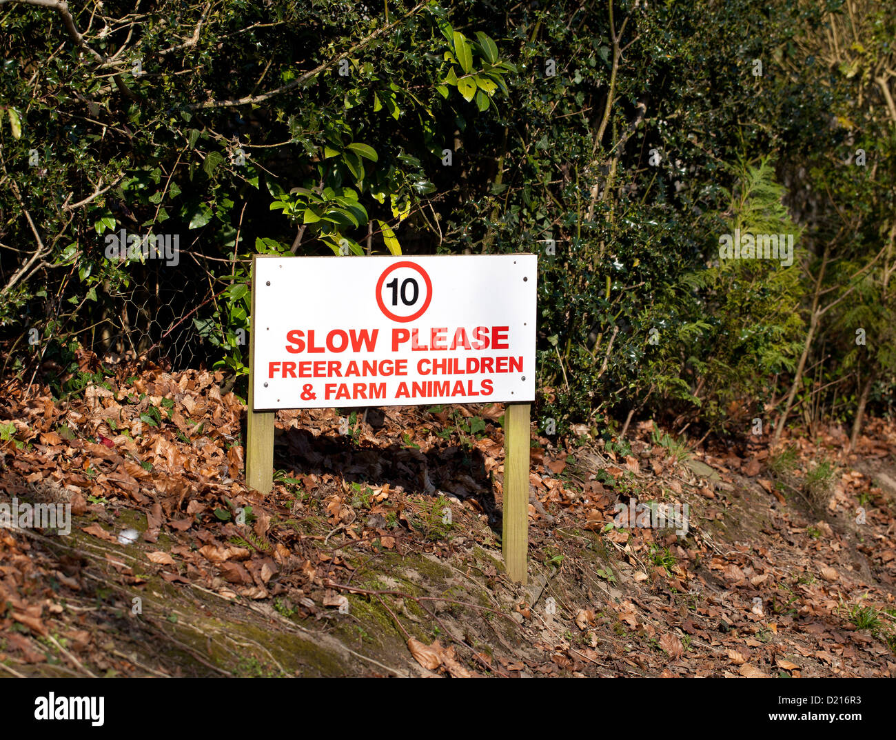 Slow Down sign warning of freerange children and farm animals Stock ...