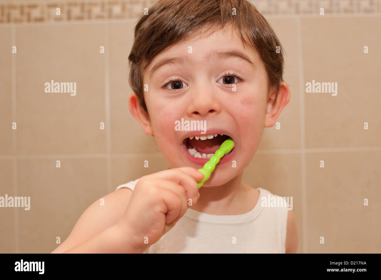 Cute boy washing his teeth. it is important to teach children from an ...