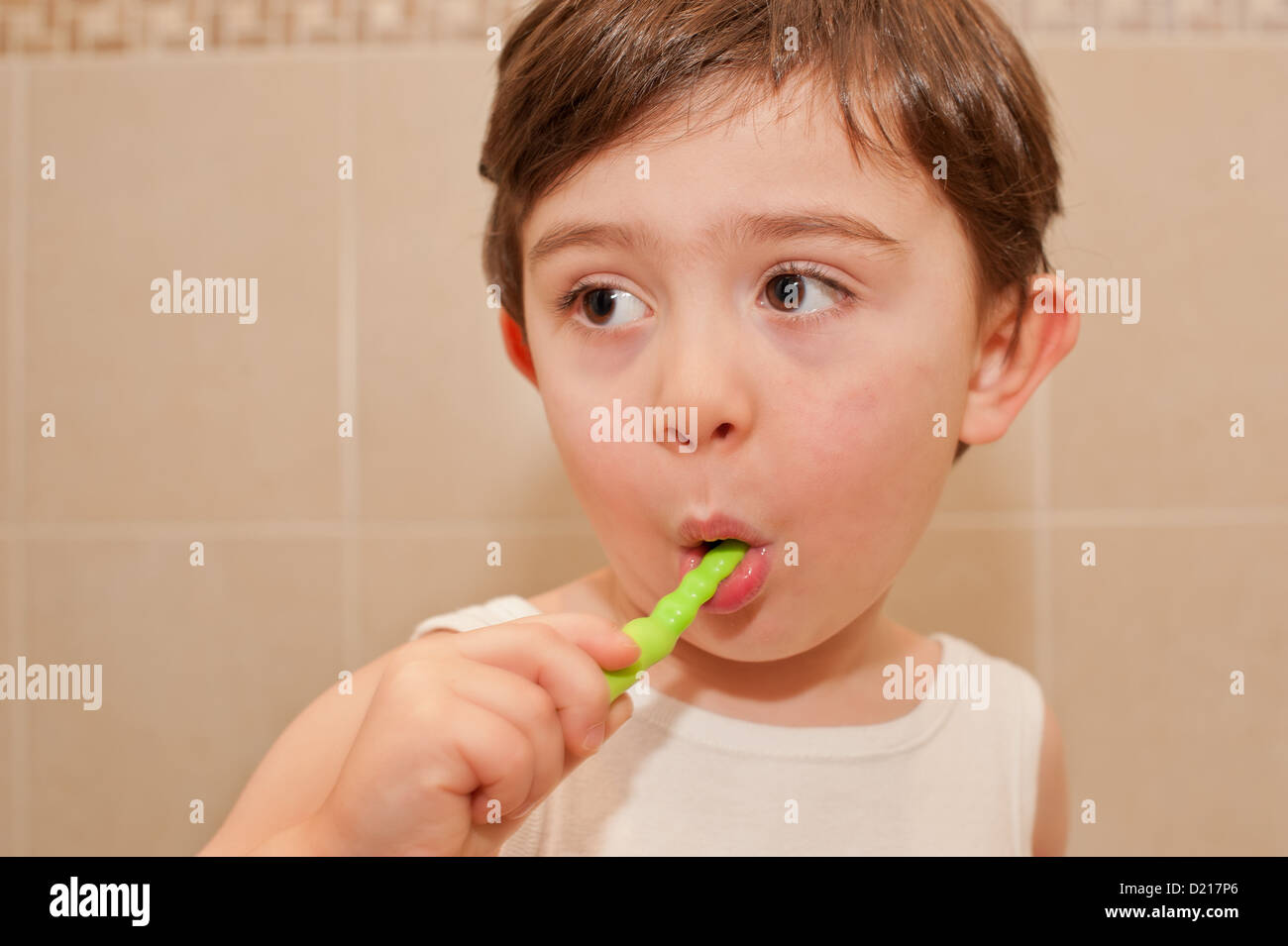 Cute boy washing his teeth. it is important to teach children from an ...
