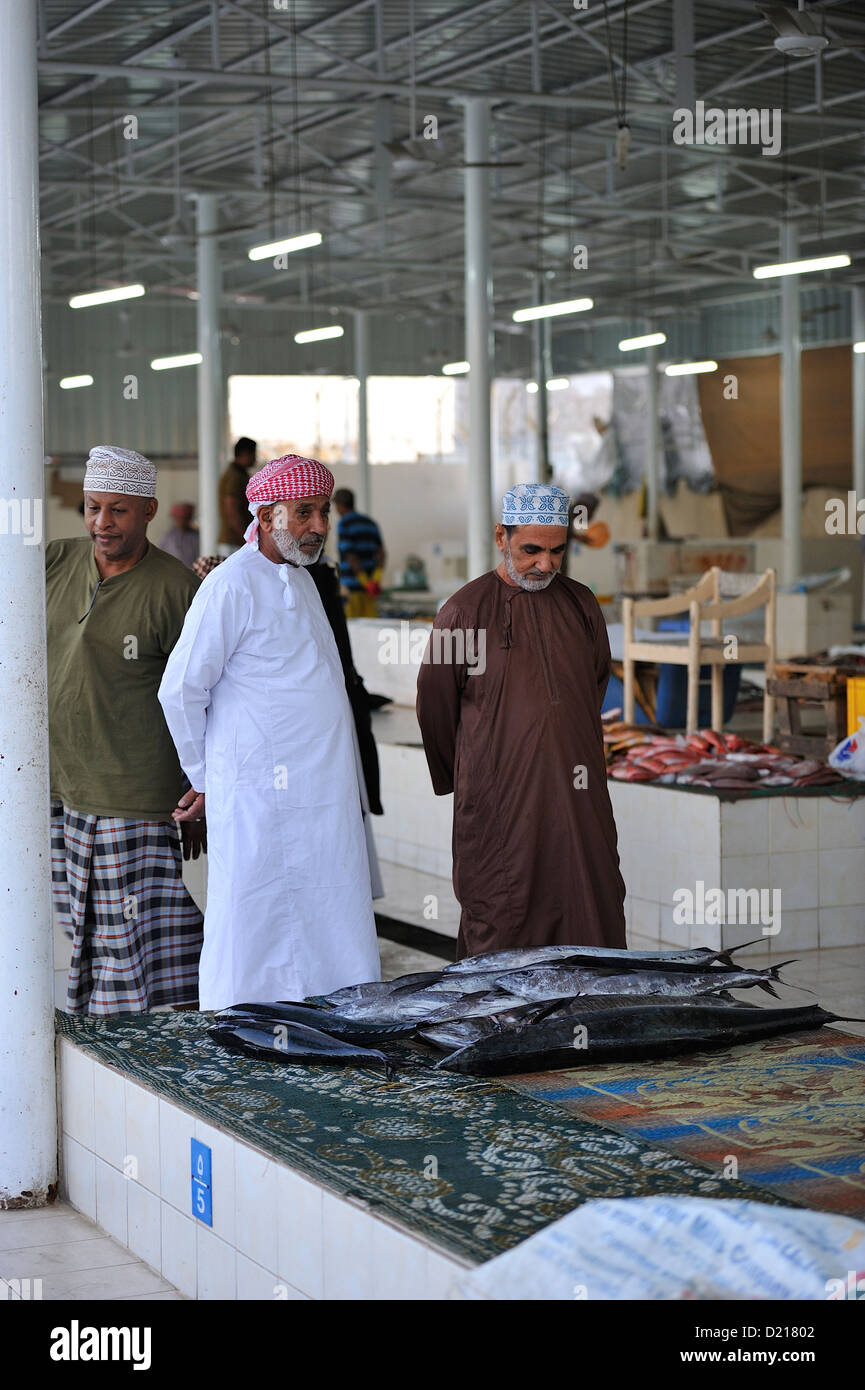 Two omani's trader take a closer look at the catch the day in the fish ...