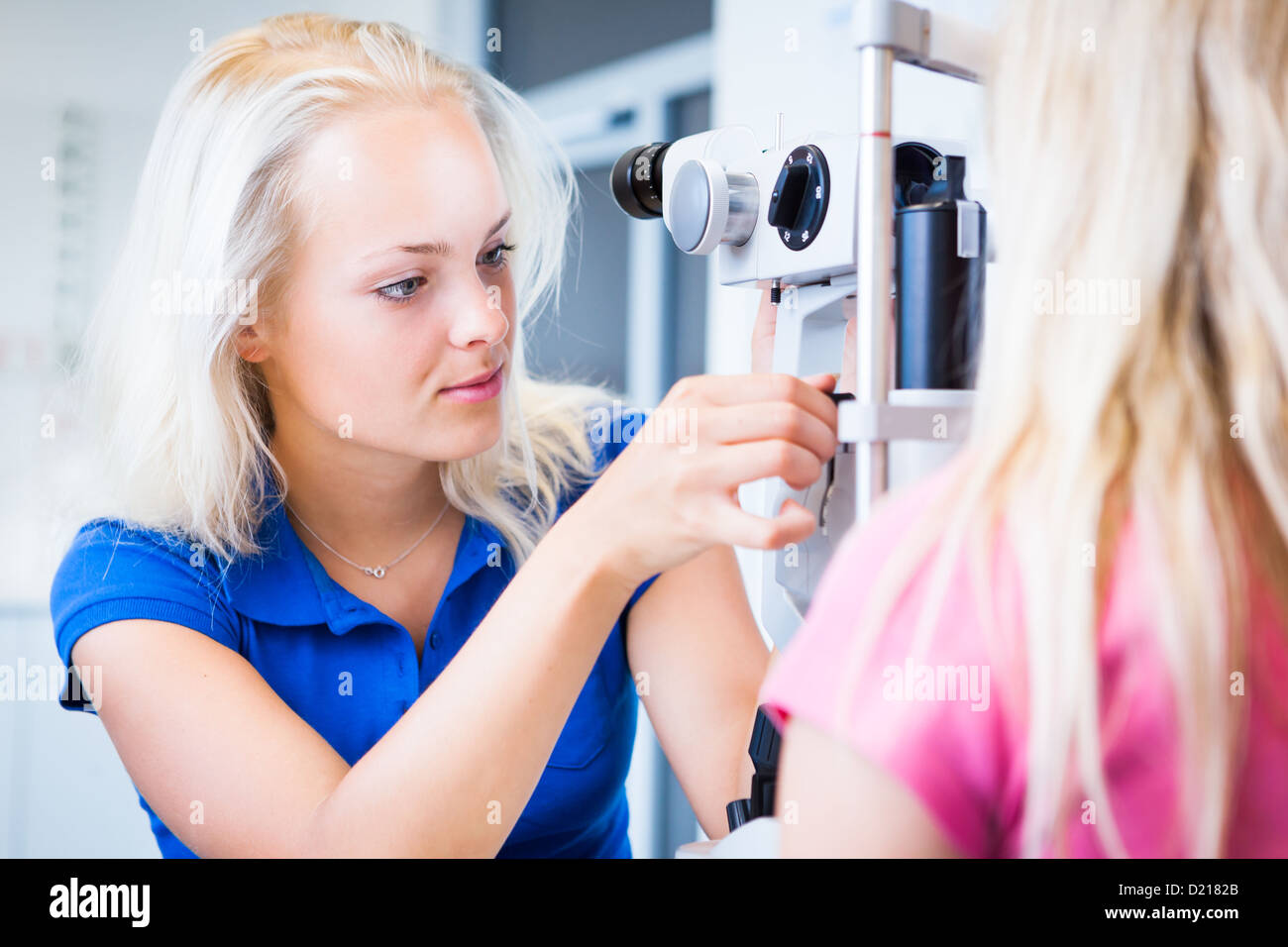 Optometry concept - pretty, young female patient having her eyes ...