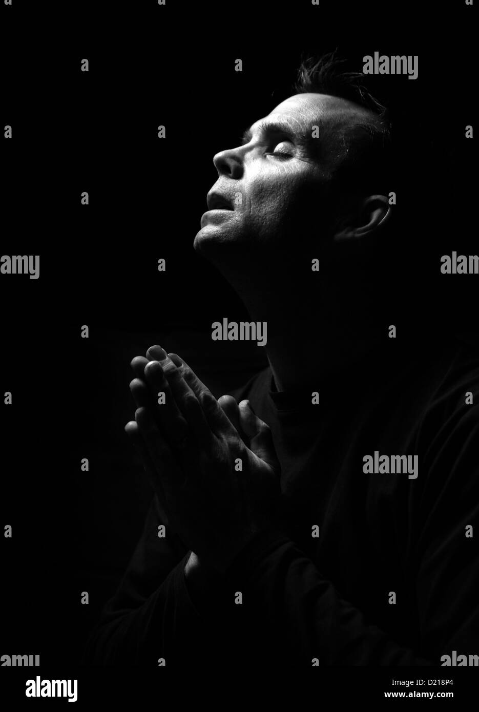 High contrast black and white image of a man praying Stock Photo - Alamy