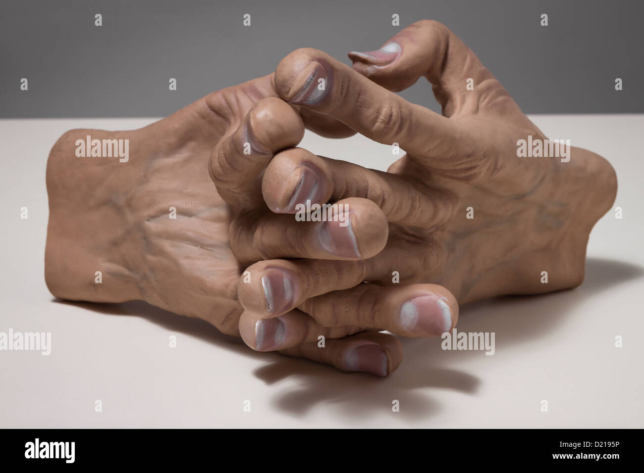huge fake hands on a white surface and gray background Stock Photo - Alamy