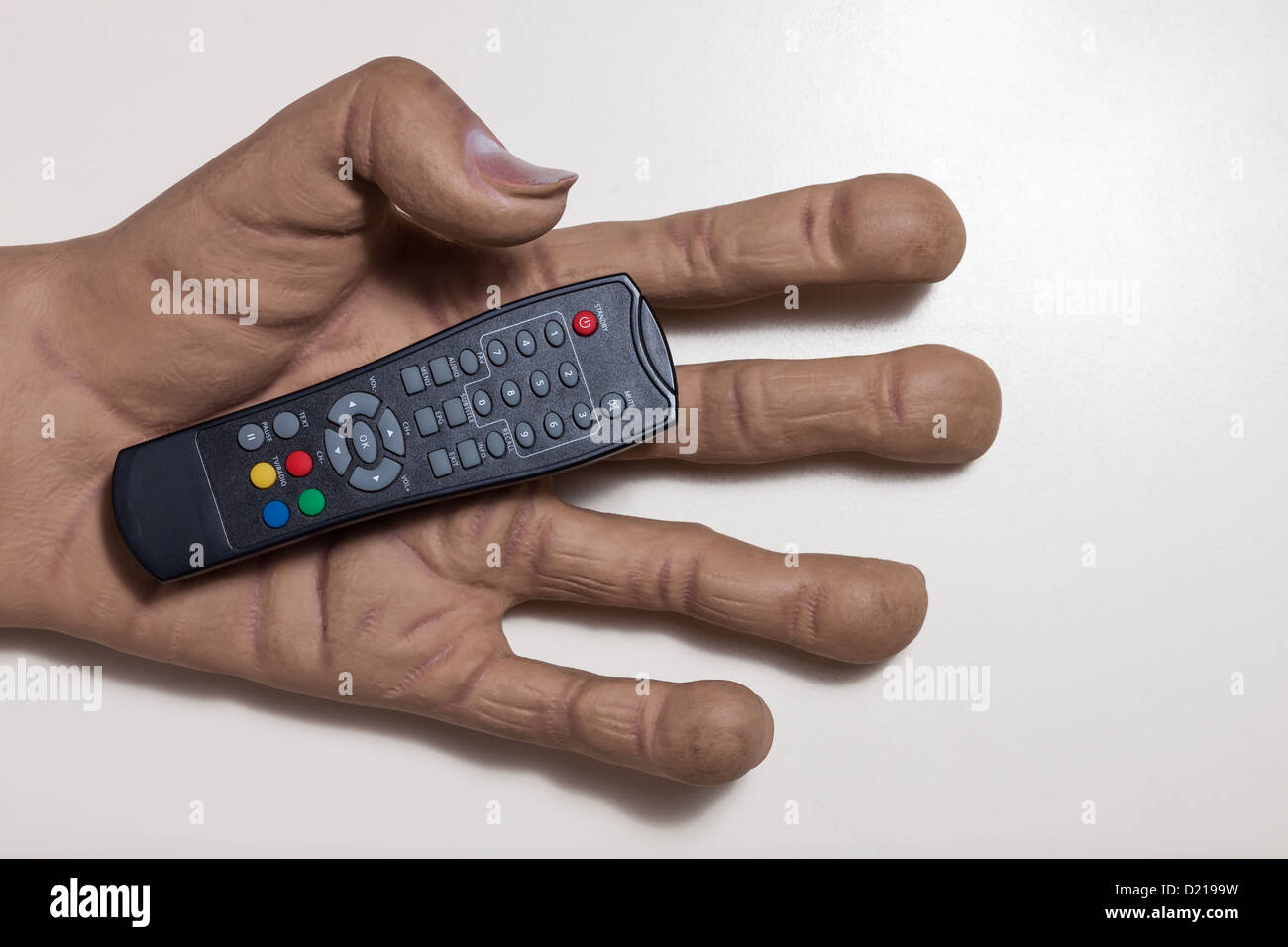 Top view of huge hand holding a tv remote control Stock Photo - Alamy