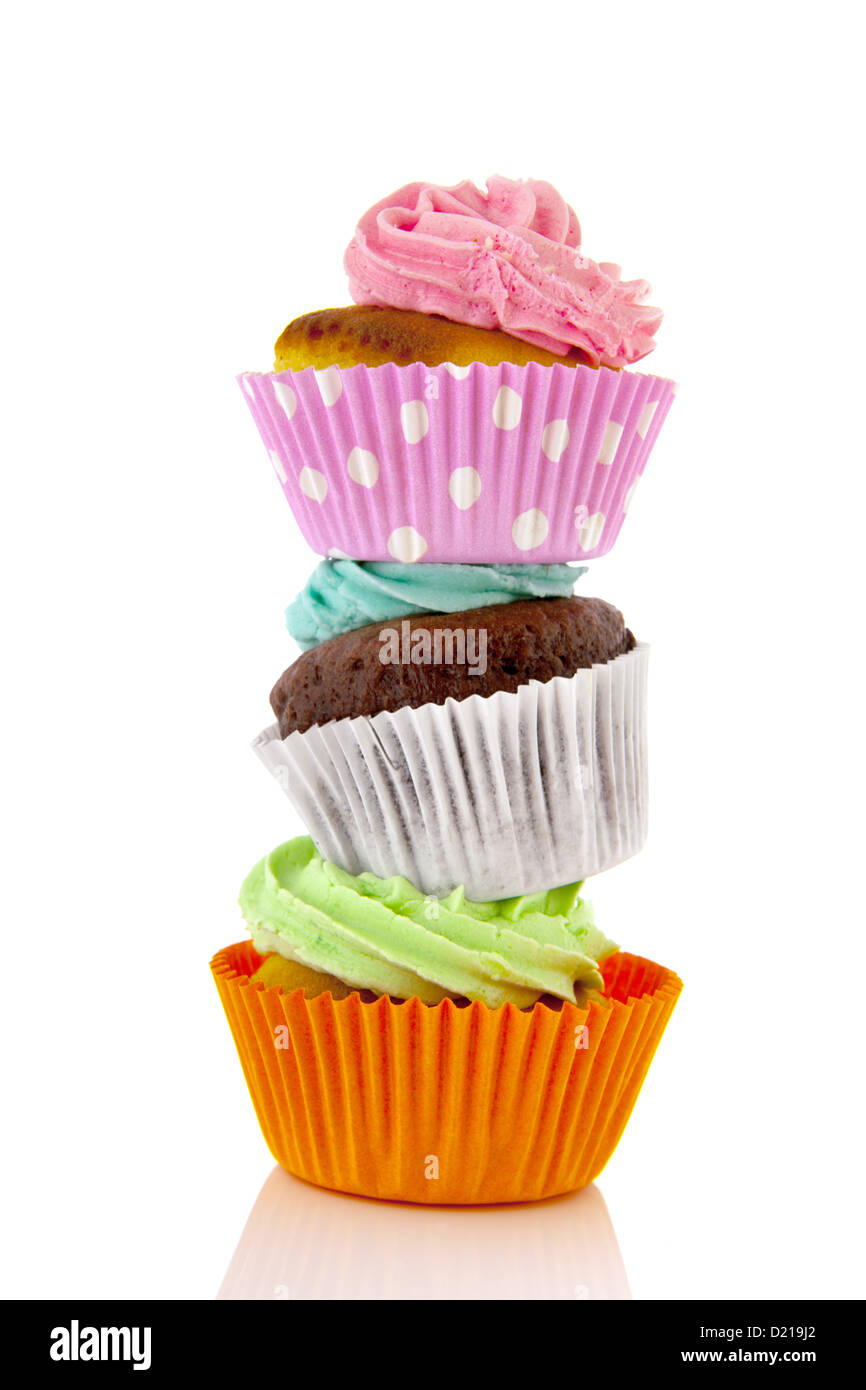 Stacked colorful cupcakes isolated over white background Stock Photo ...
