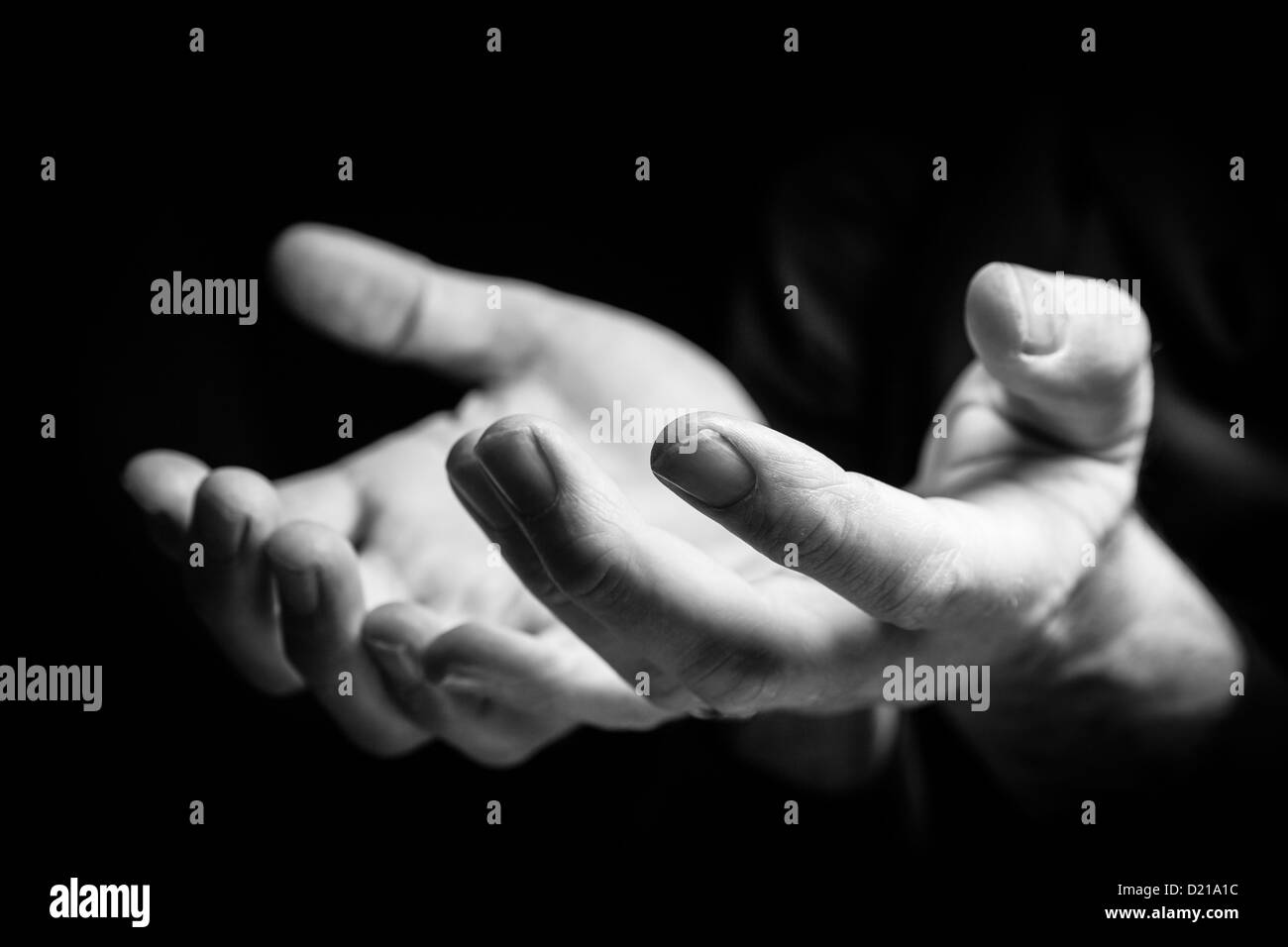 Two hands outstretched begging Stock Photo - Alamy