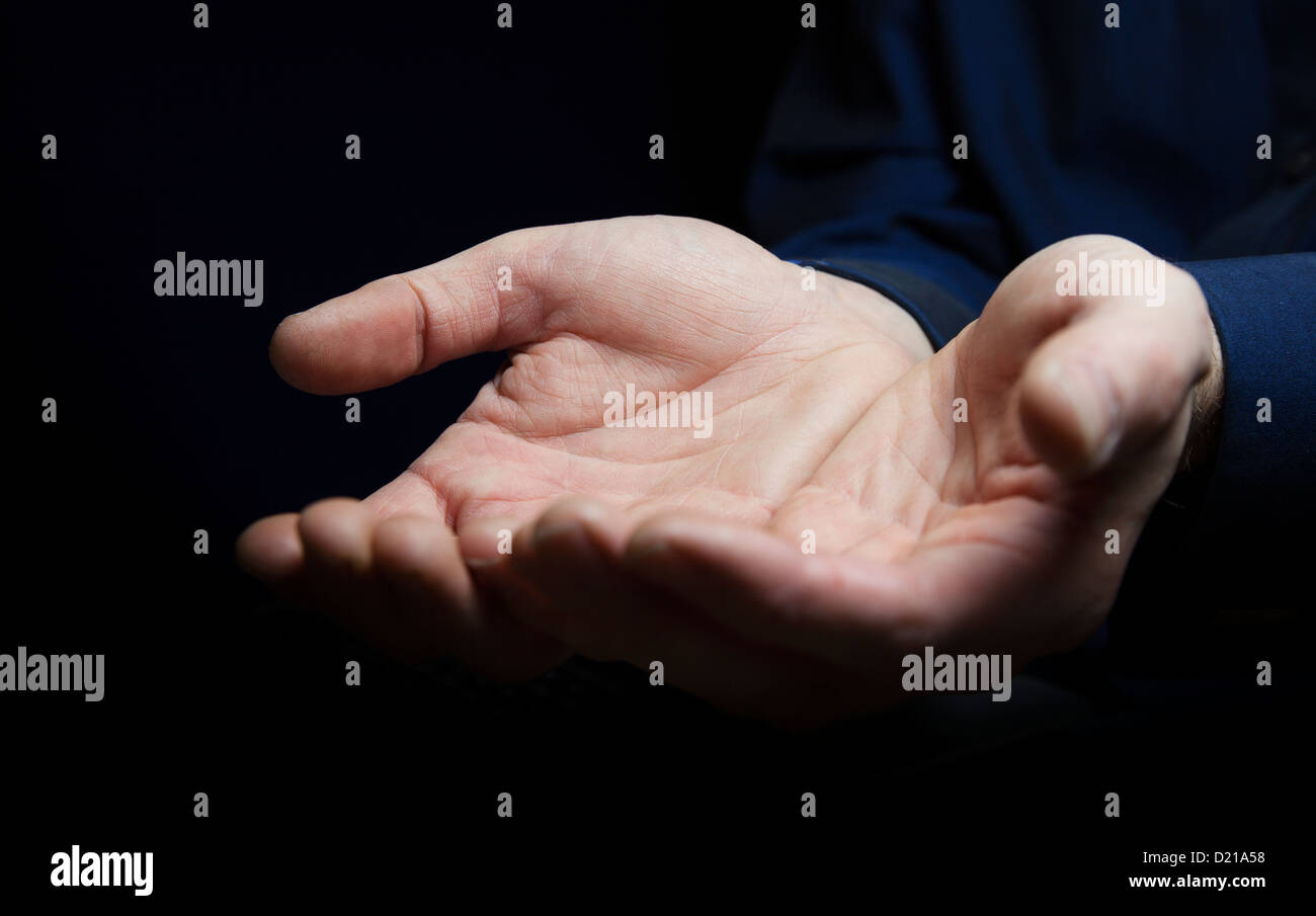 Two hands outstretched begging Stock Photo - Alamy