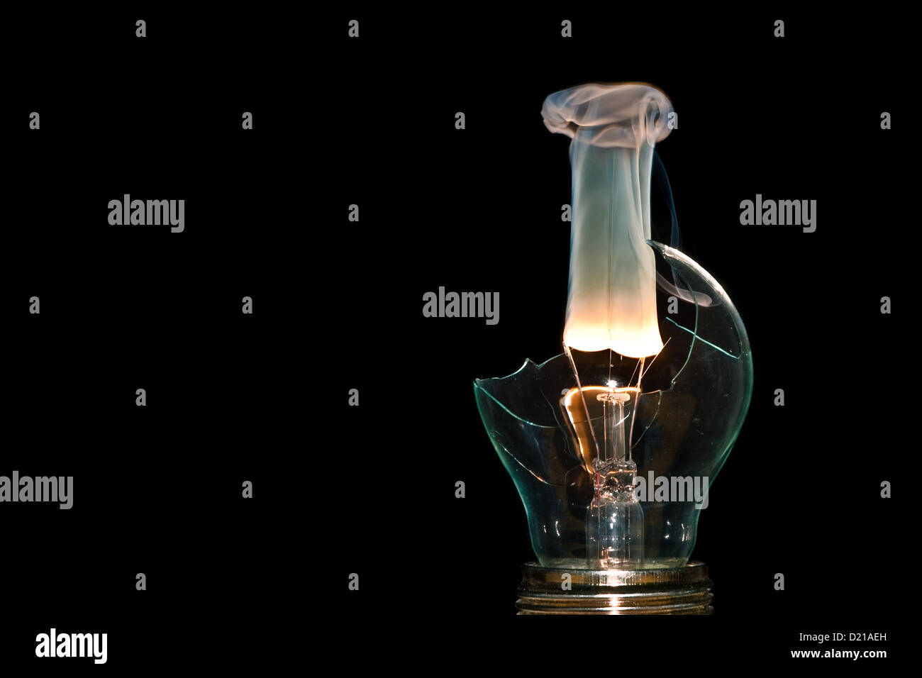 Broken light bulb burns out with smoke on a black background Stock ...