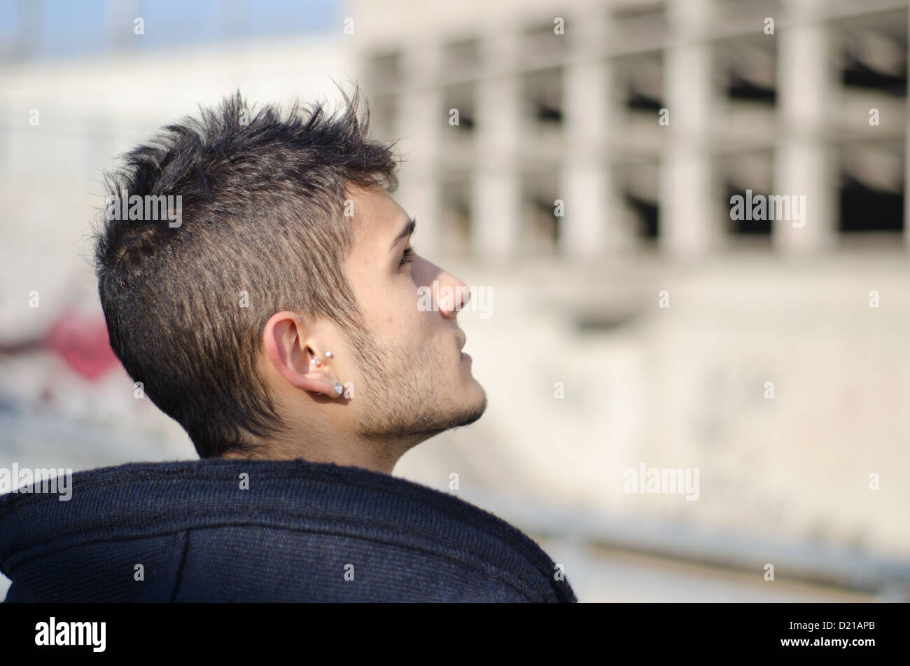 Attractive young man looking up, profile shot Stock Photo - Alamy