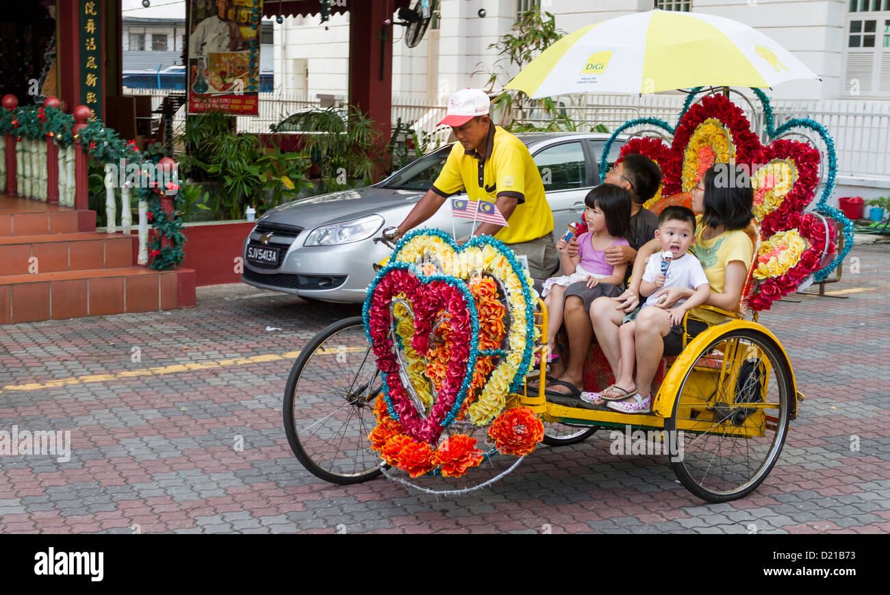 Tourists on trishaw ride in Melaka, Malaysia, are a popular tourist ...