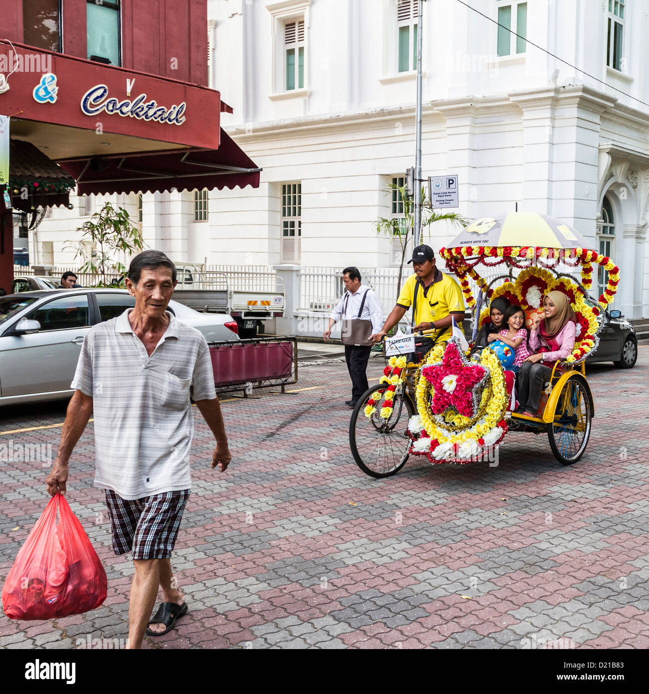 Tourists on trishaw ride in Melaka, Malaysia, are a popular tourist ...