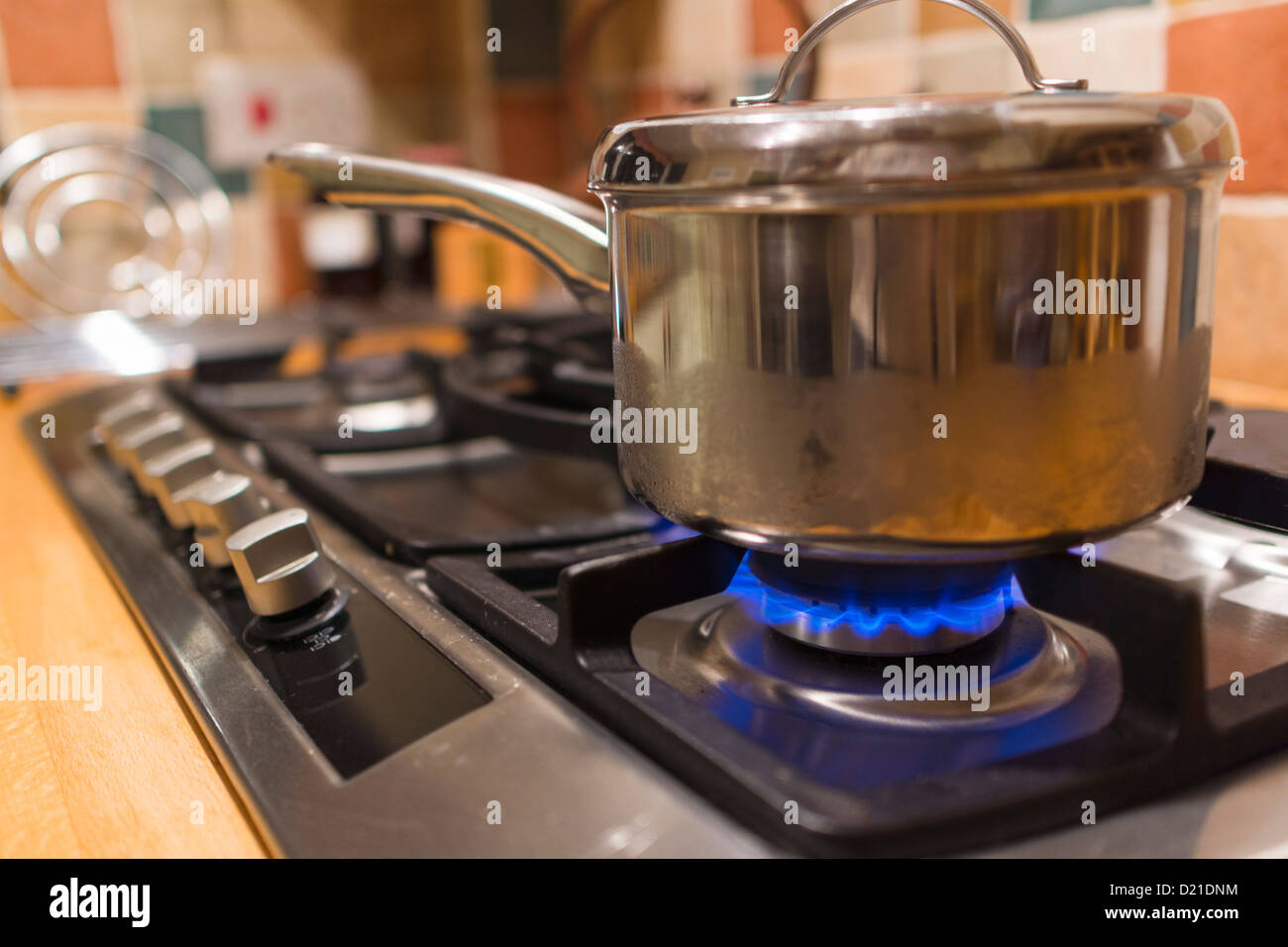 A steel cooking pan on gas stove Stock Photo - Alamy