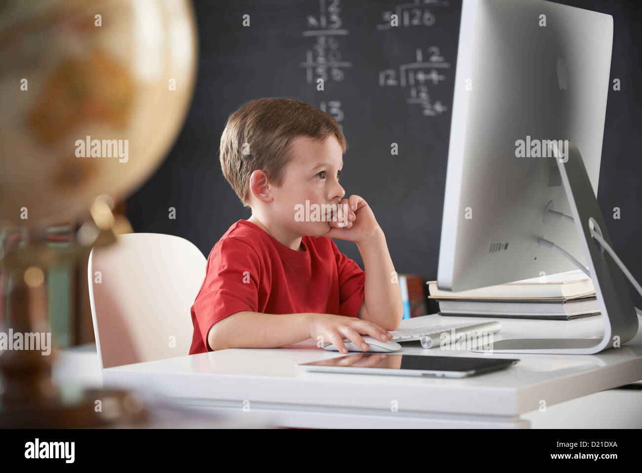 School boy in the classroom with ipad hi-res stock photography and ...