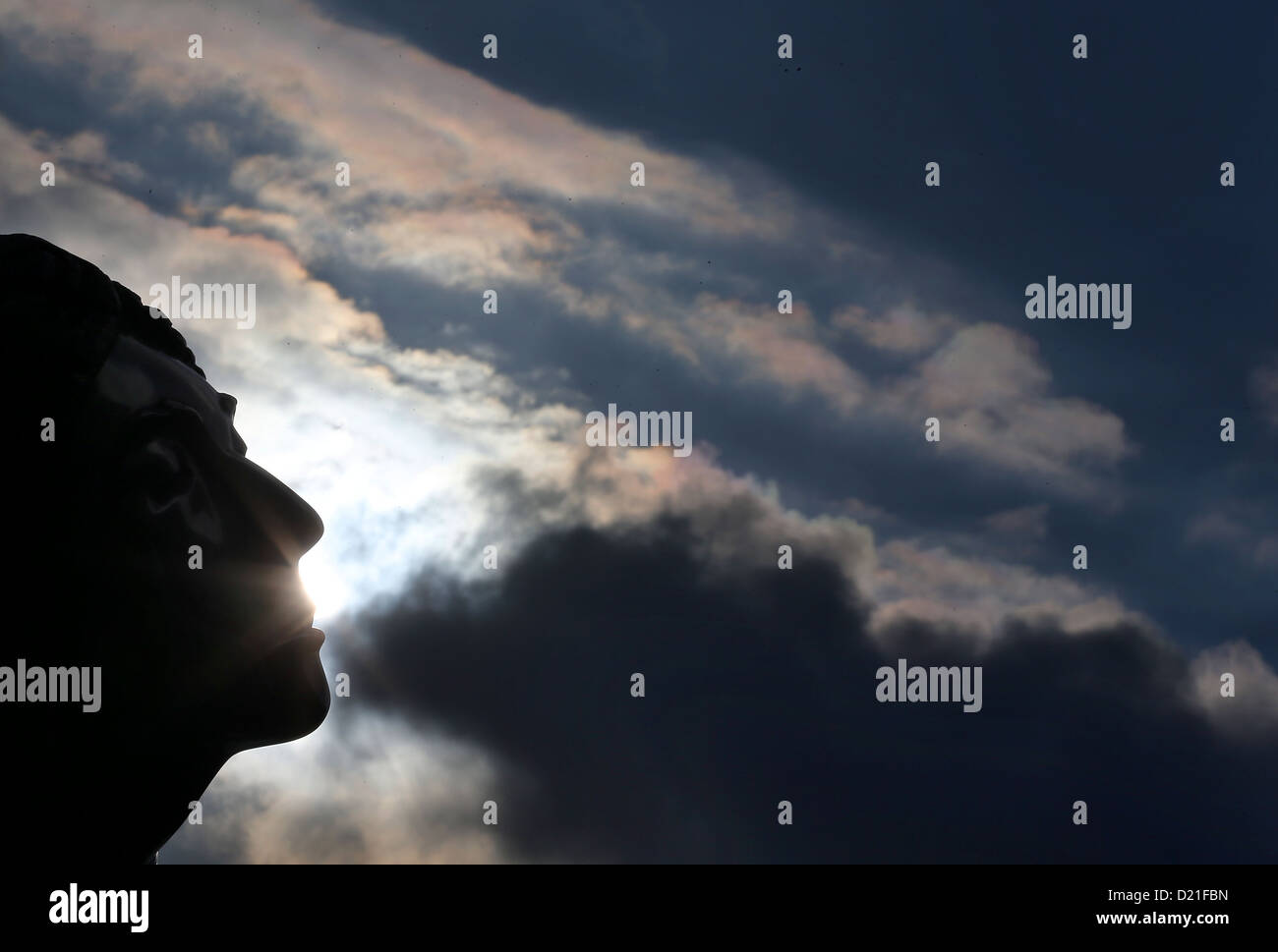 The clouds break apart behind a sculpture of Thomas Schuette in Cologne ...