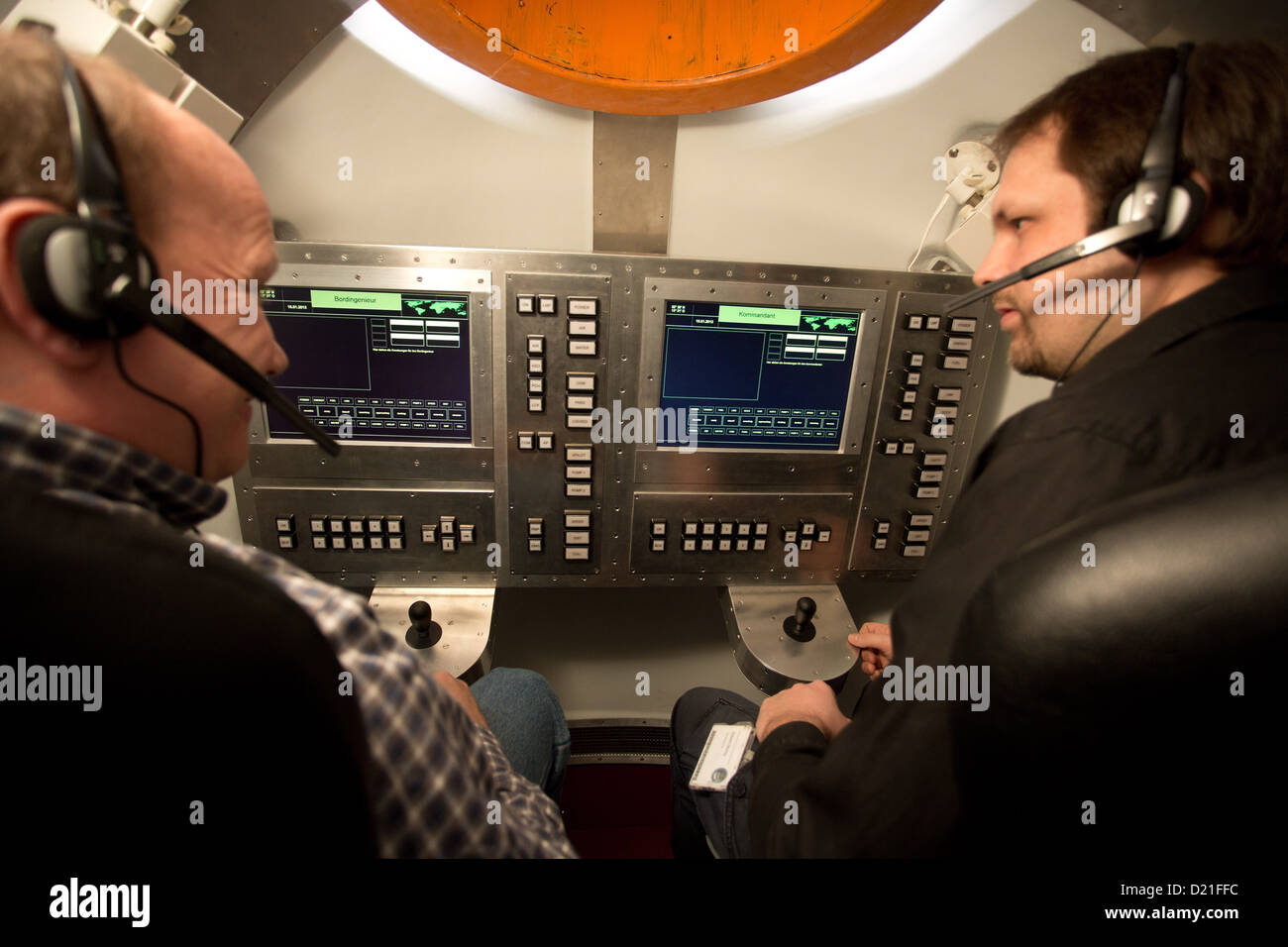 Visitors sit in a Sojus flight simulator during the 10th anniversary ...