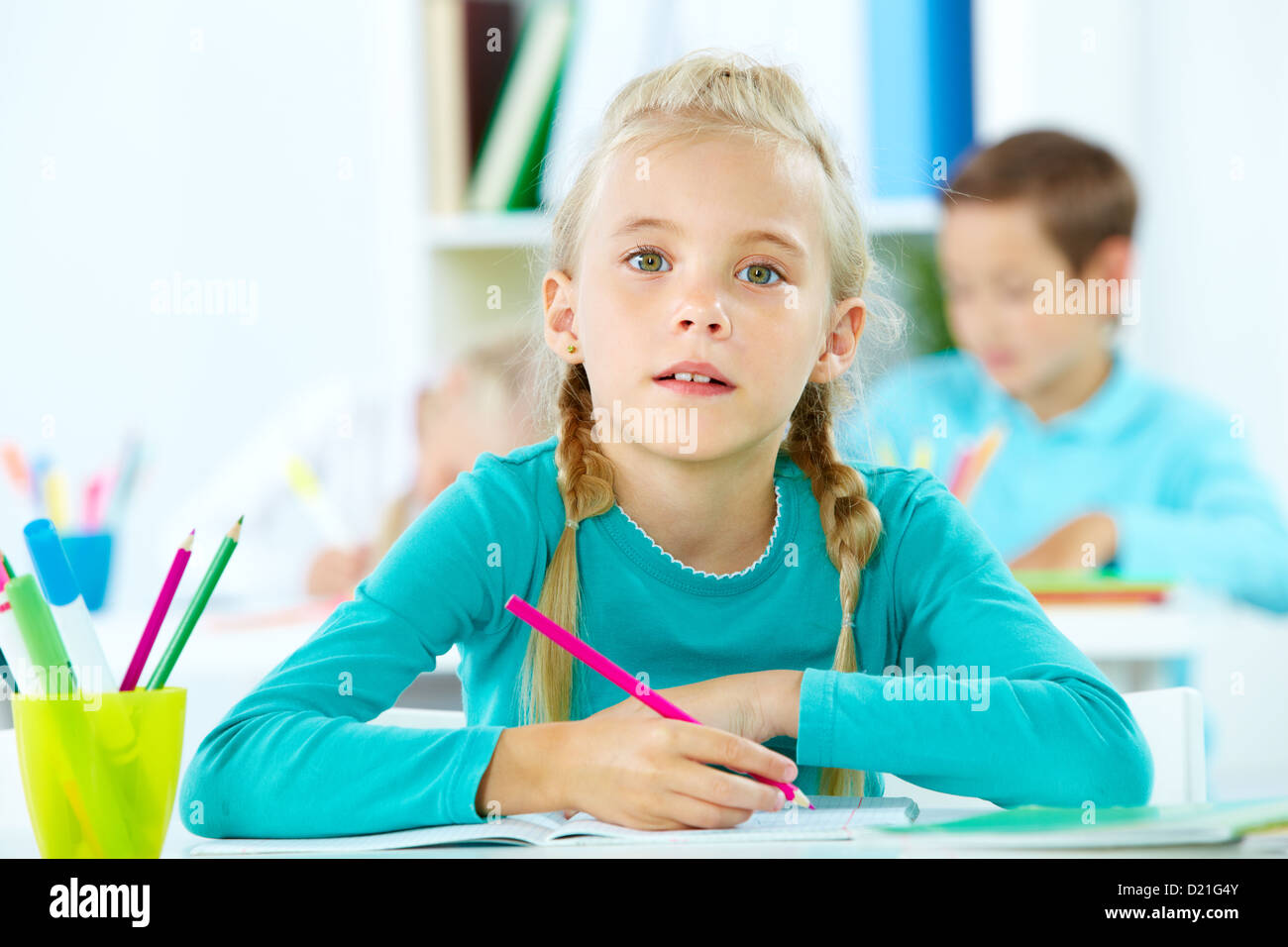 Portrait of a cute girl doing tasks at school Stock Photo - Alamy
