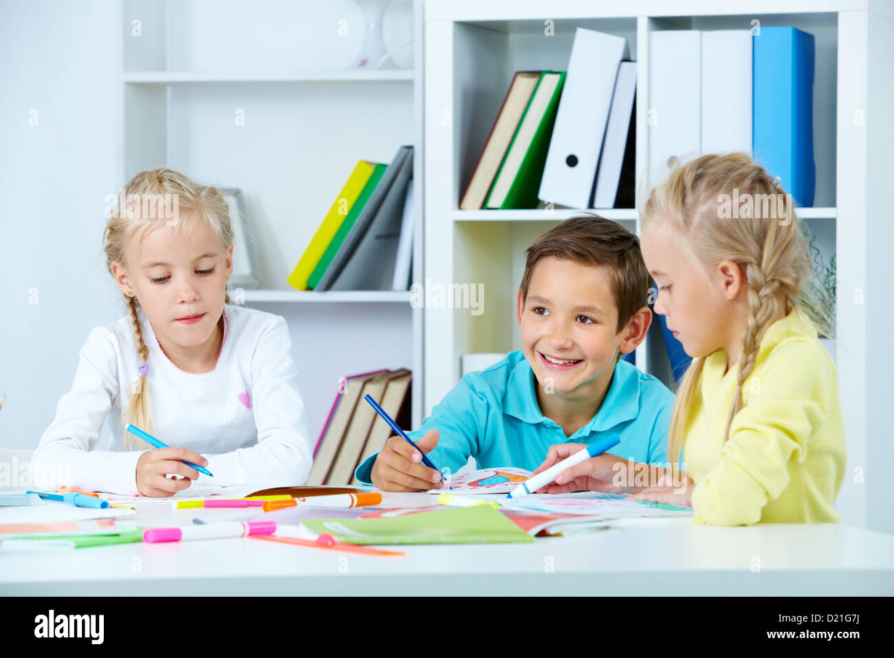 Classmates improving their artistic skills drawing together Stock Photo ...