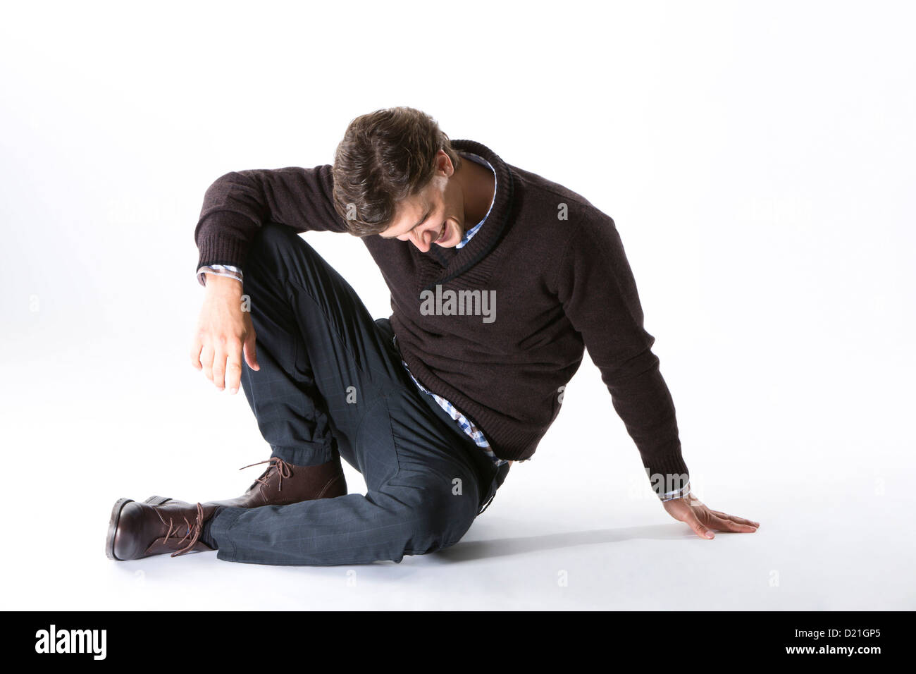Young man looking down, smiling Stock Photo - Alamy
