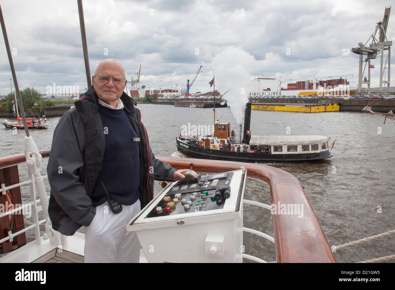 Captain Klaus Mueller maneuvers sailing cruise ship Star Flyer on Elbe ...