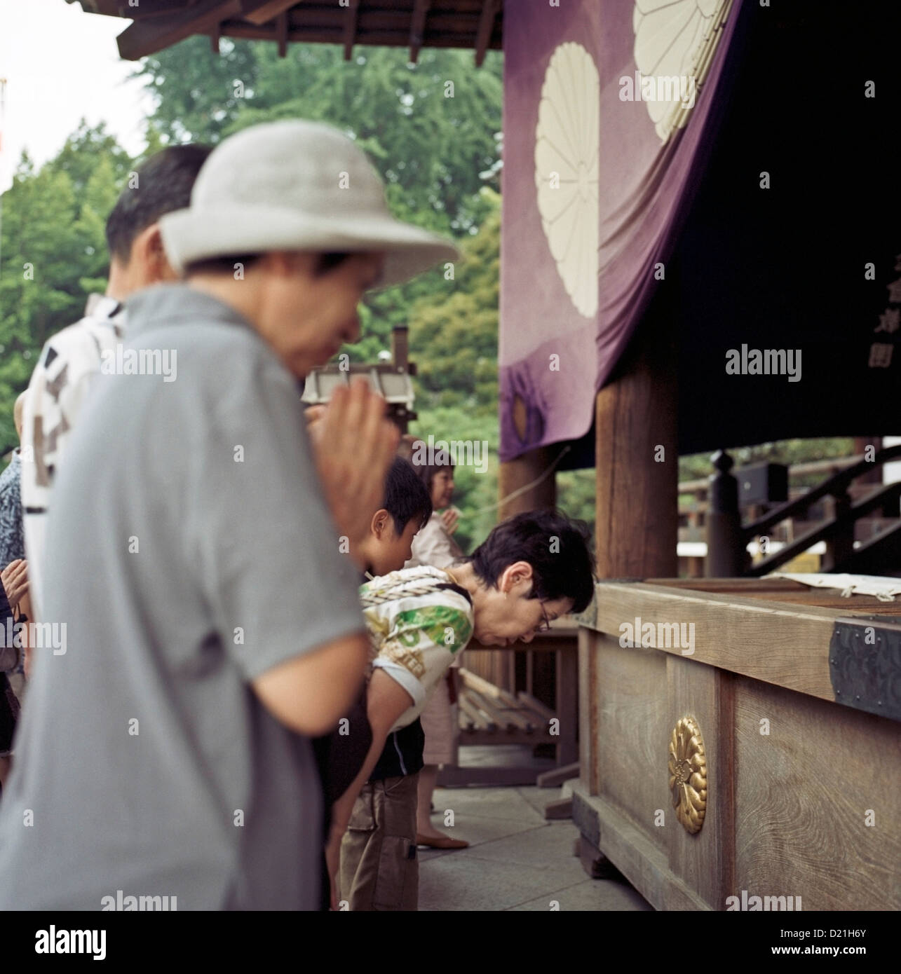 People pray at the main hall of worship at the Yasukuni Shrine in Tokyo ...
