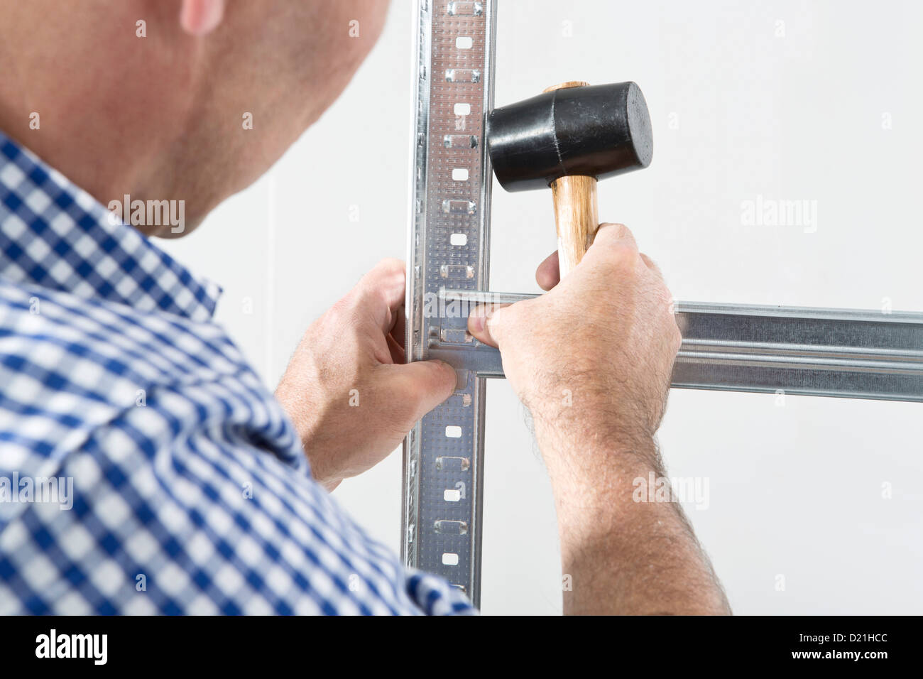 Mature man building shelf Stock Photo - Alamy