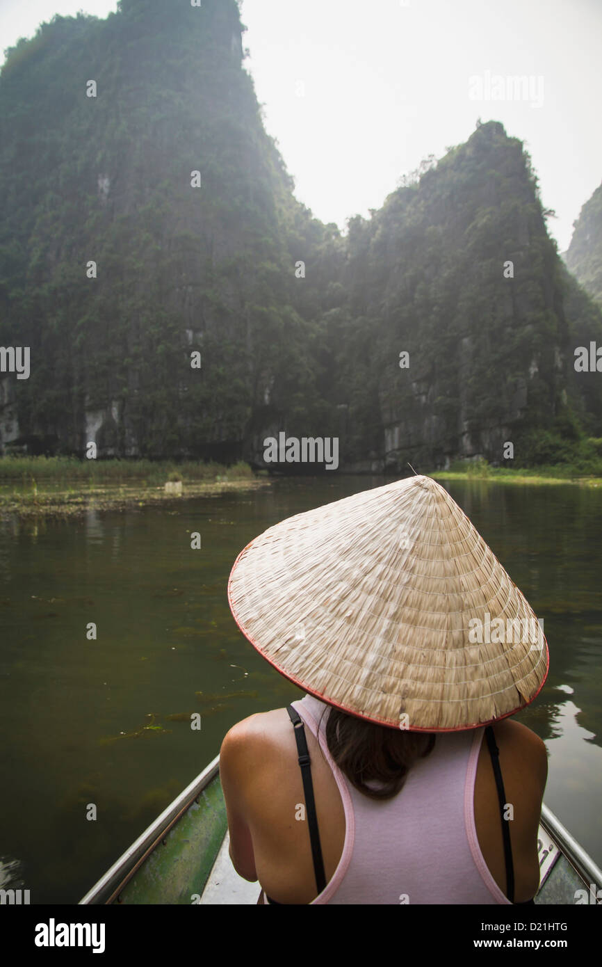 Vietnam, Ninh Binh, Young tourist taking photograph of Tom Coc Stock ...