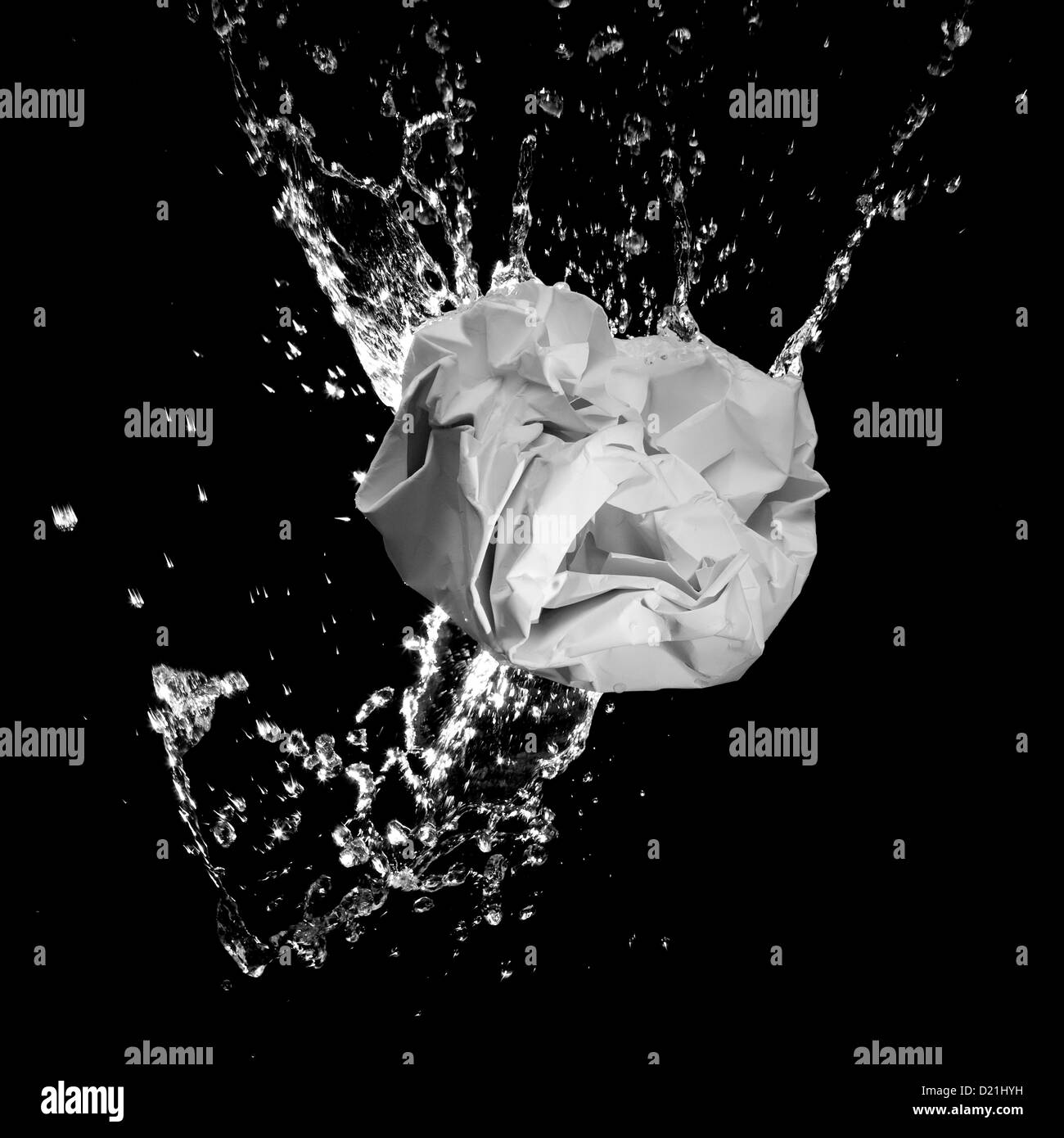 Crumpled paper ball splashing into water, close up Stock Photo - Alamy