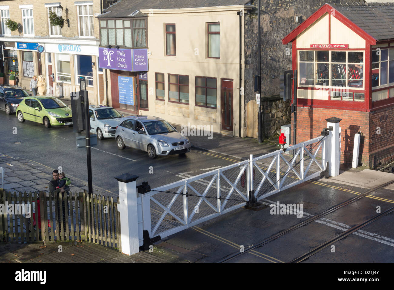 Traffic and pedestrians waiting at Ramsbottom level crossing gates on ...