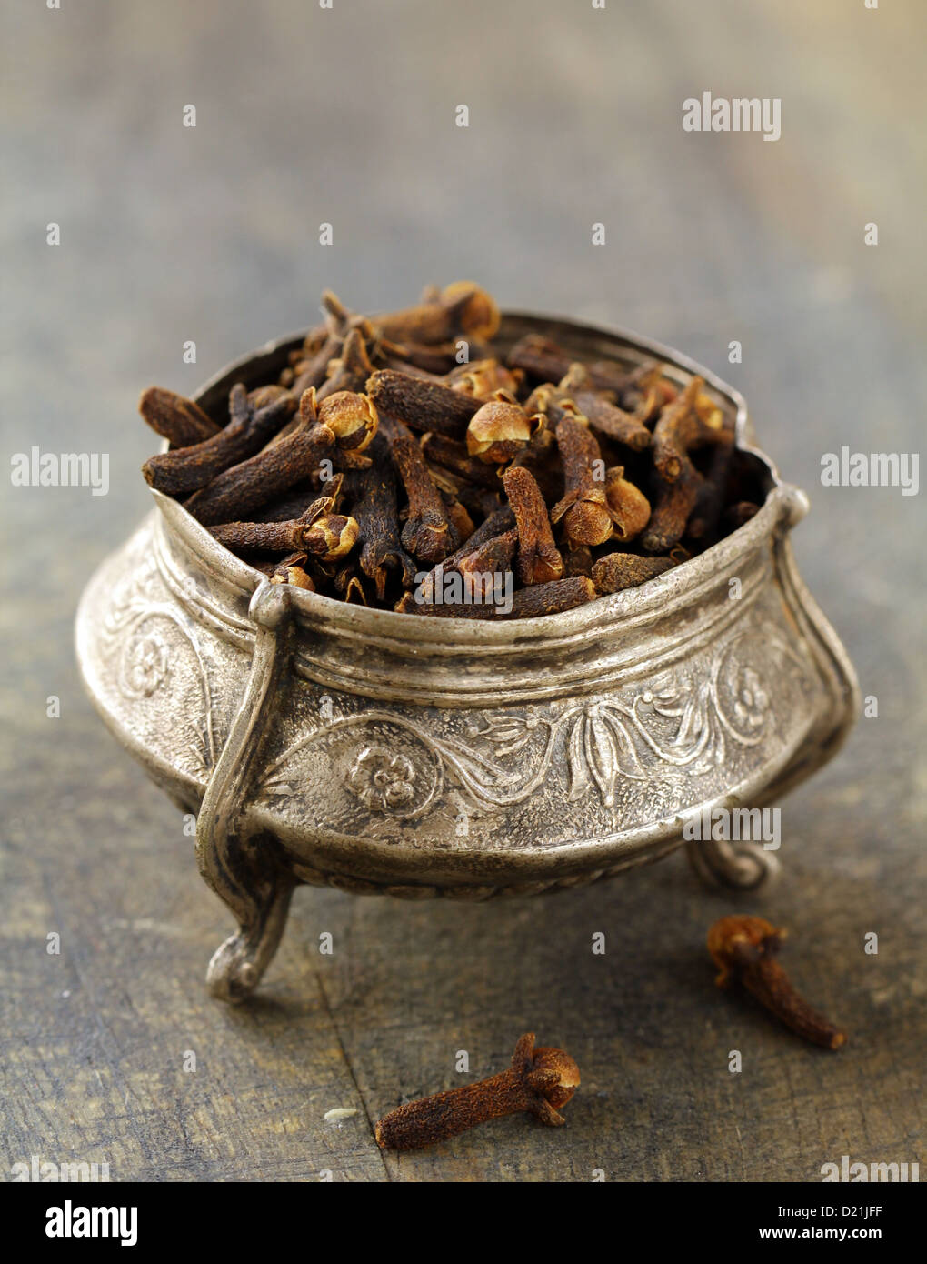 Dried spice cloves on a wooden table Stock Photo - Alamy