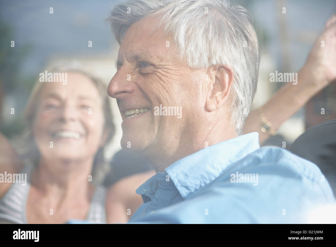 Spain, Senior couple behind glass window, smiling Stock Photo - Alamy