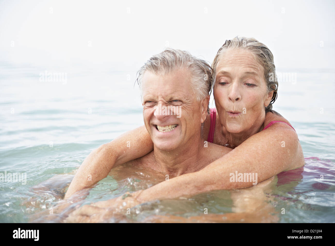Spain, Senior couple swimming in sea Stock Photo - Alamy