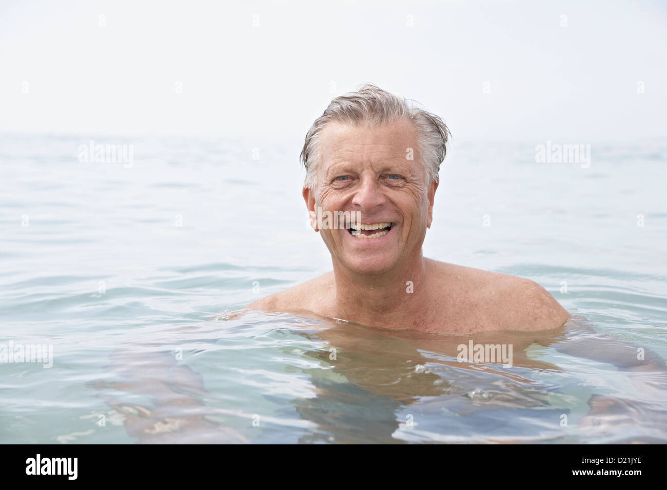 Spain, Senior man swimming in sea Stock Photo - Alamy