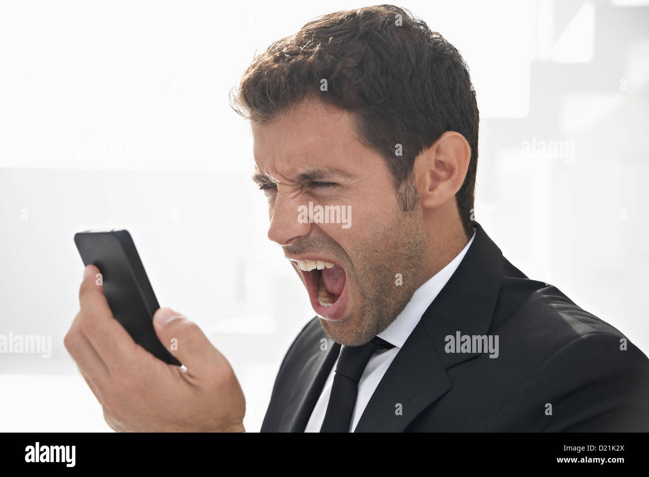 Spain, Businessman shouting on mobile phone Stock Photo - Alamy