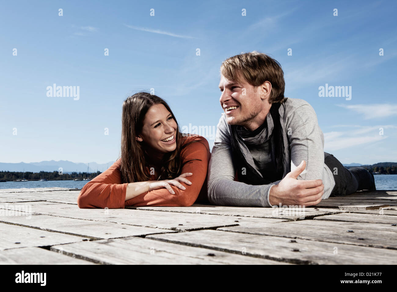 Germany, Bavaria, Couple lying on jetty at Lake Starnberg Stock Photo - Alamy
