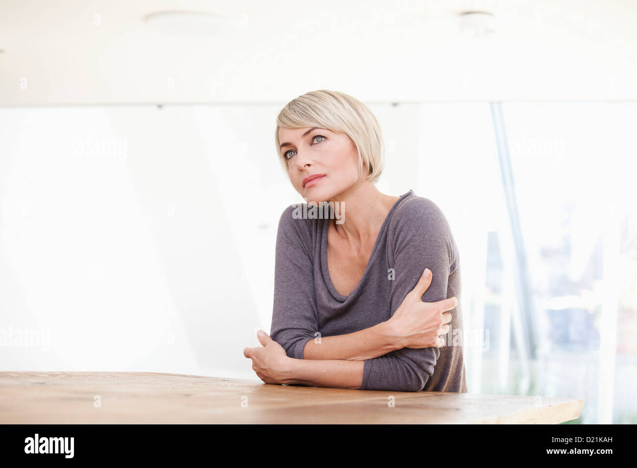 Germany, Bavaria, Munich, Woman thinking at table Stock Photo - Alamy