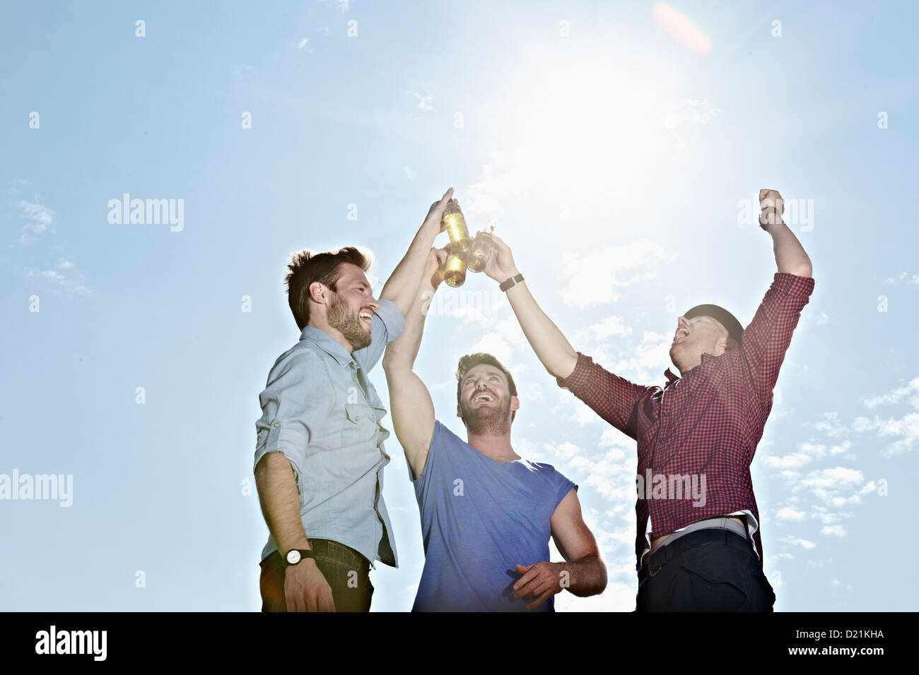 Germany, Cologne, Young men drinking beer Stock Photo - Alamy