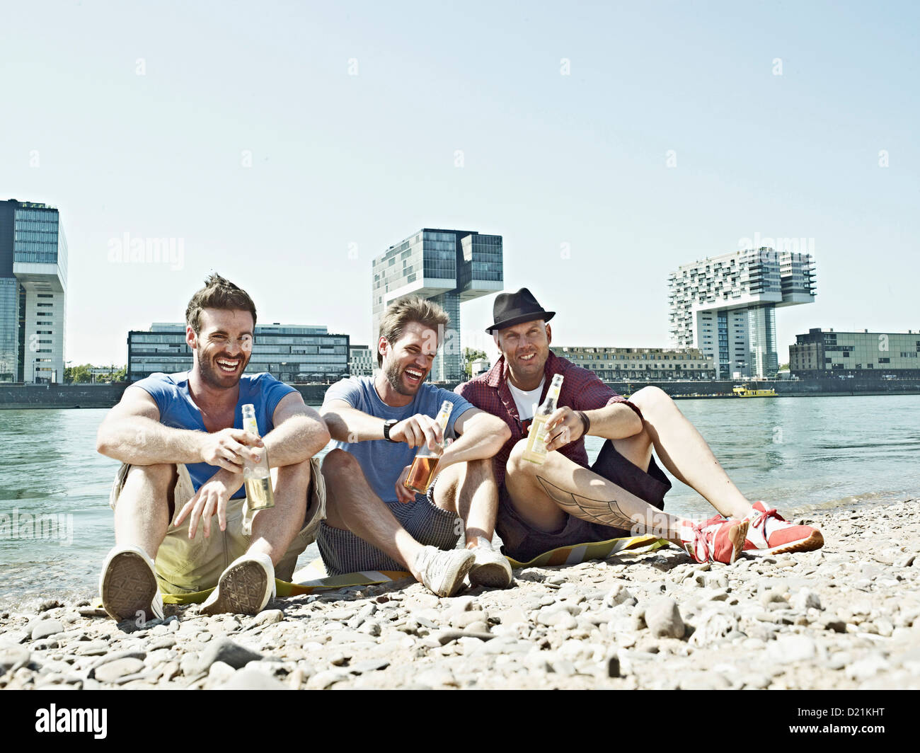 Germany, Cologne, Young men drinking beer Stock Photo - Alamy