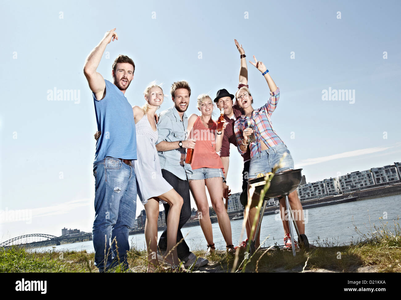 Germany, Cologne, Group of people gathered around barbecue Stock Photo ...