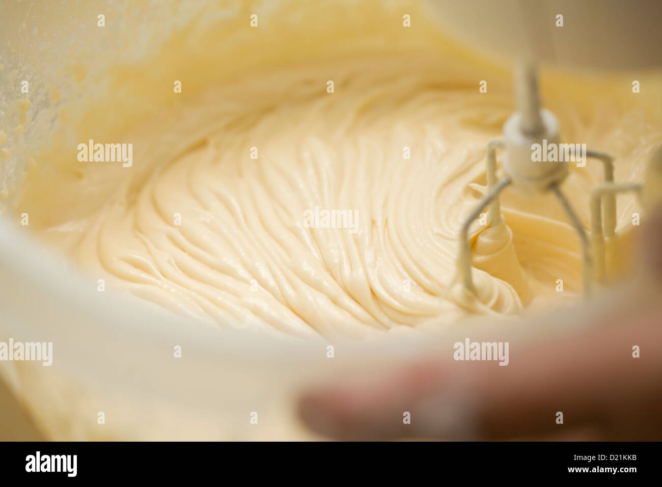 Europe, Germany, North Rhine Westphalia, Human hand mixing batter with ...