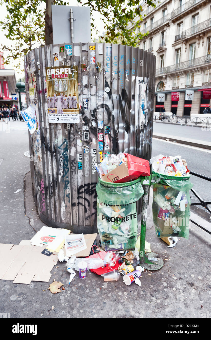 Overflowing litter bins by a public lavatory on a city street - Paris ...