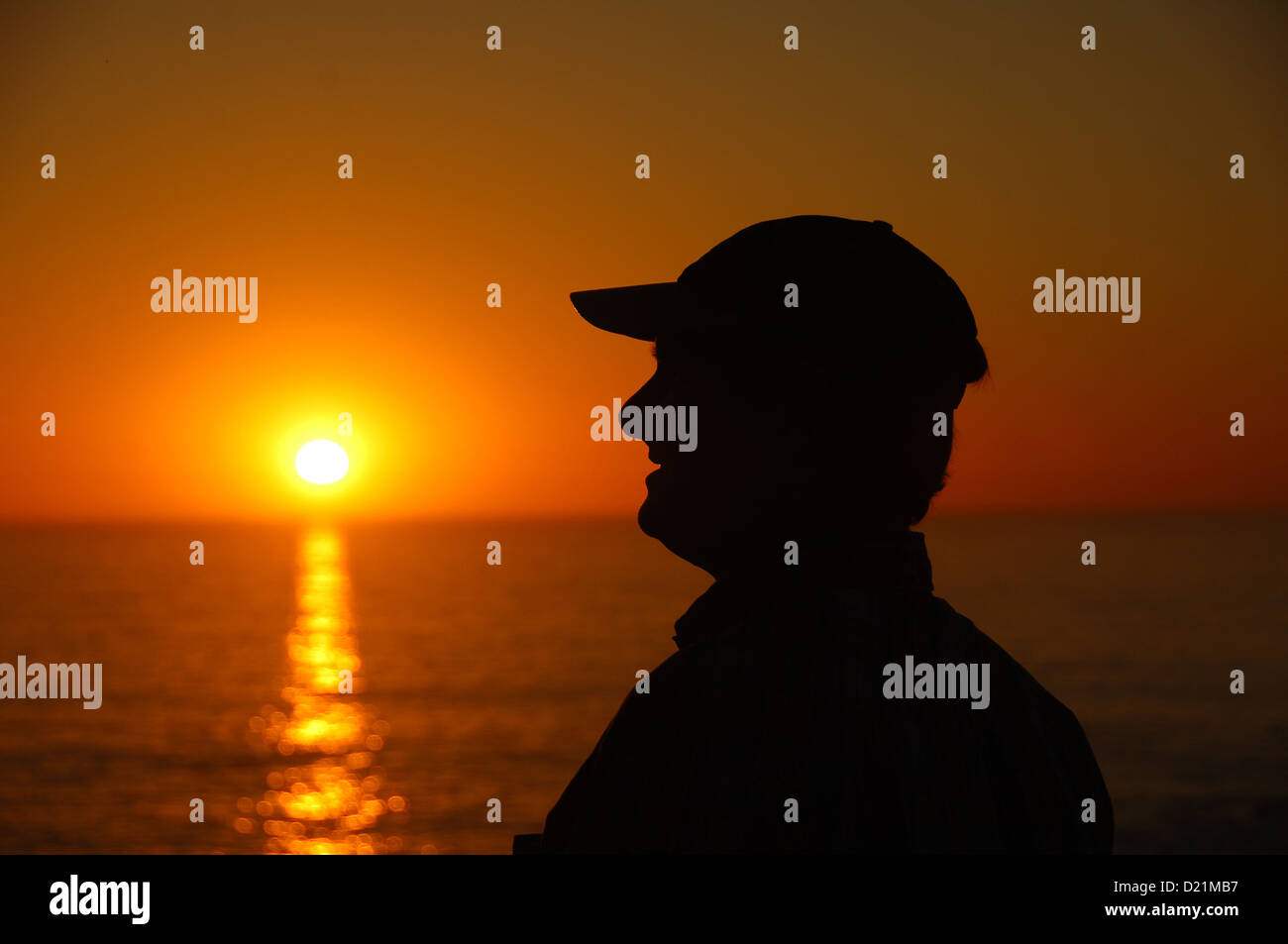 silhouette of men in sunset Stock Photo - Alamy