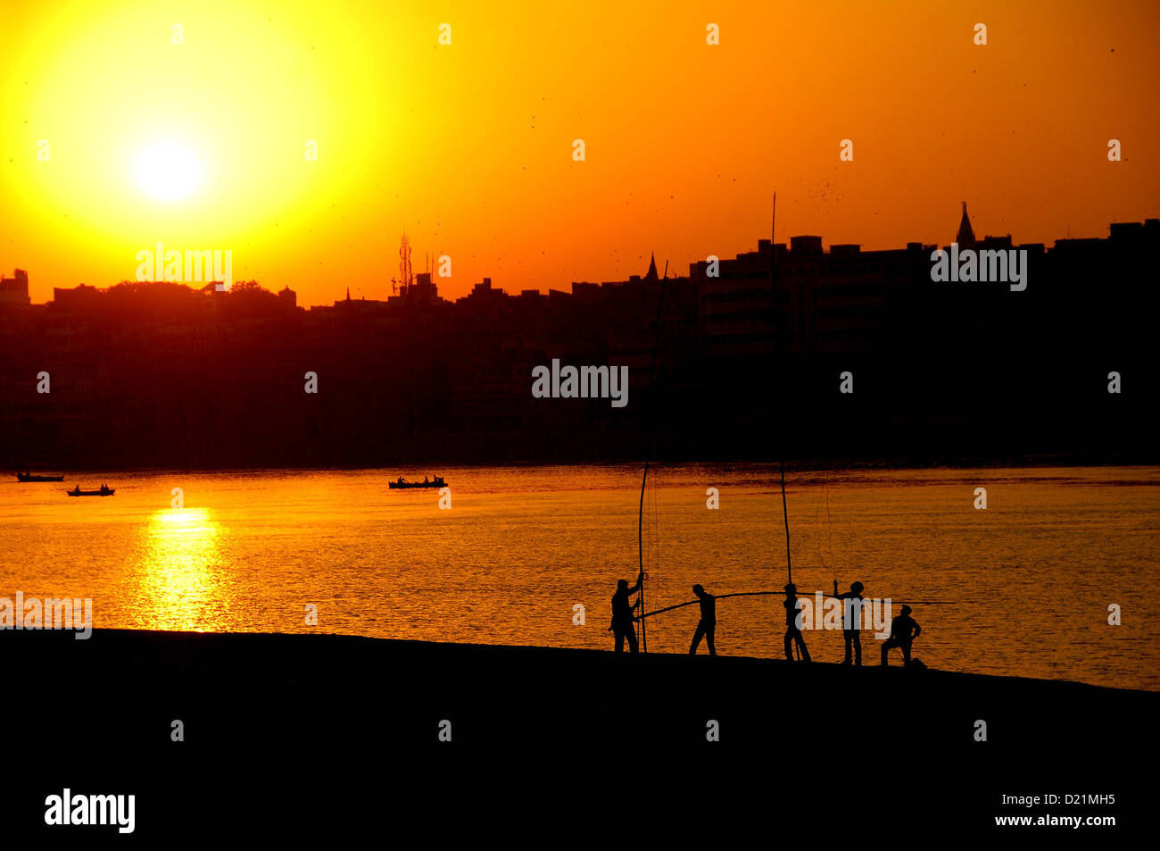 fishermen's working in front of river Stock Photo - Alamy