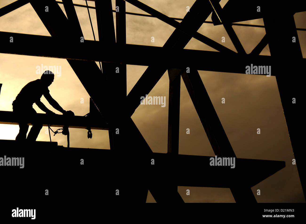 silhouette of men working on bridge Stock Photo - Alamy