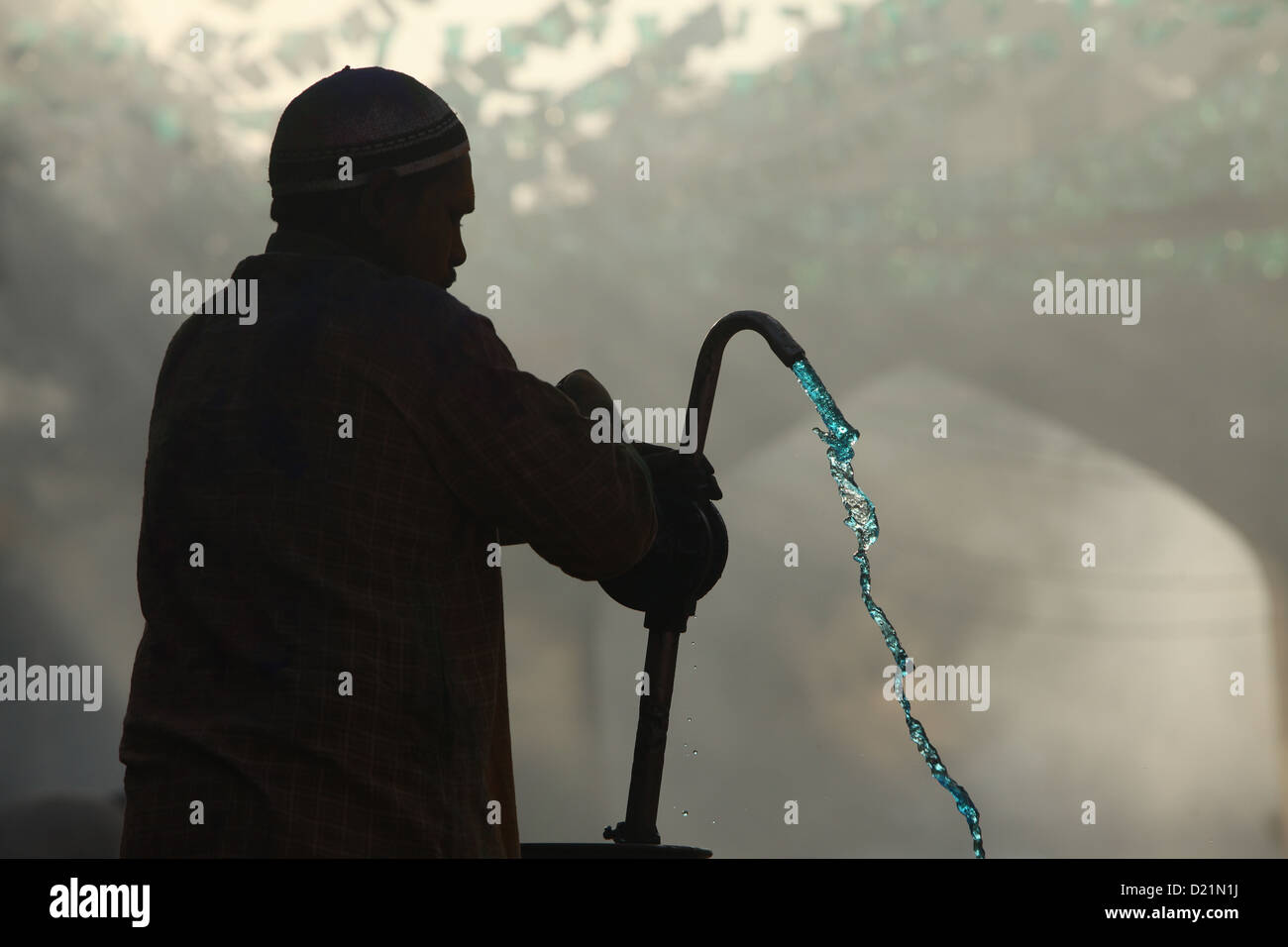 man pumping oil Stock Photo - Alamy