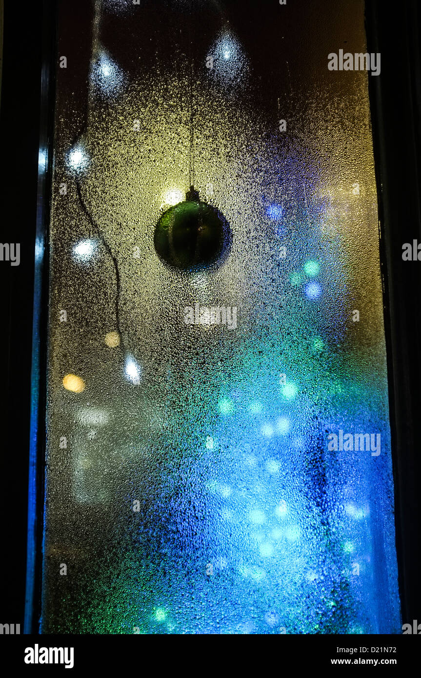 Condensation on a shop window, with bright lights glowing sparkling ...