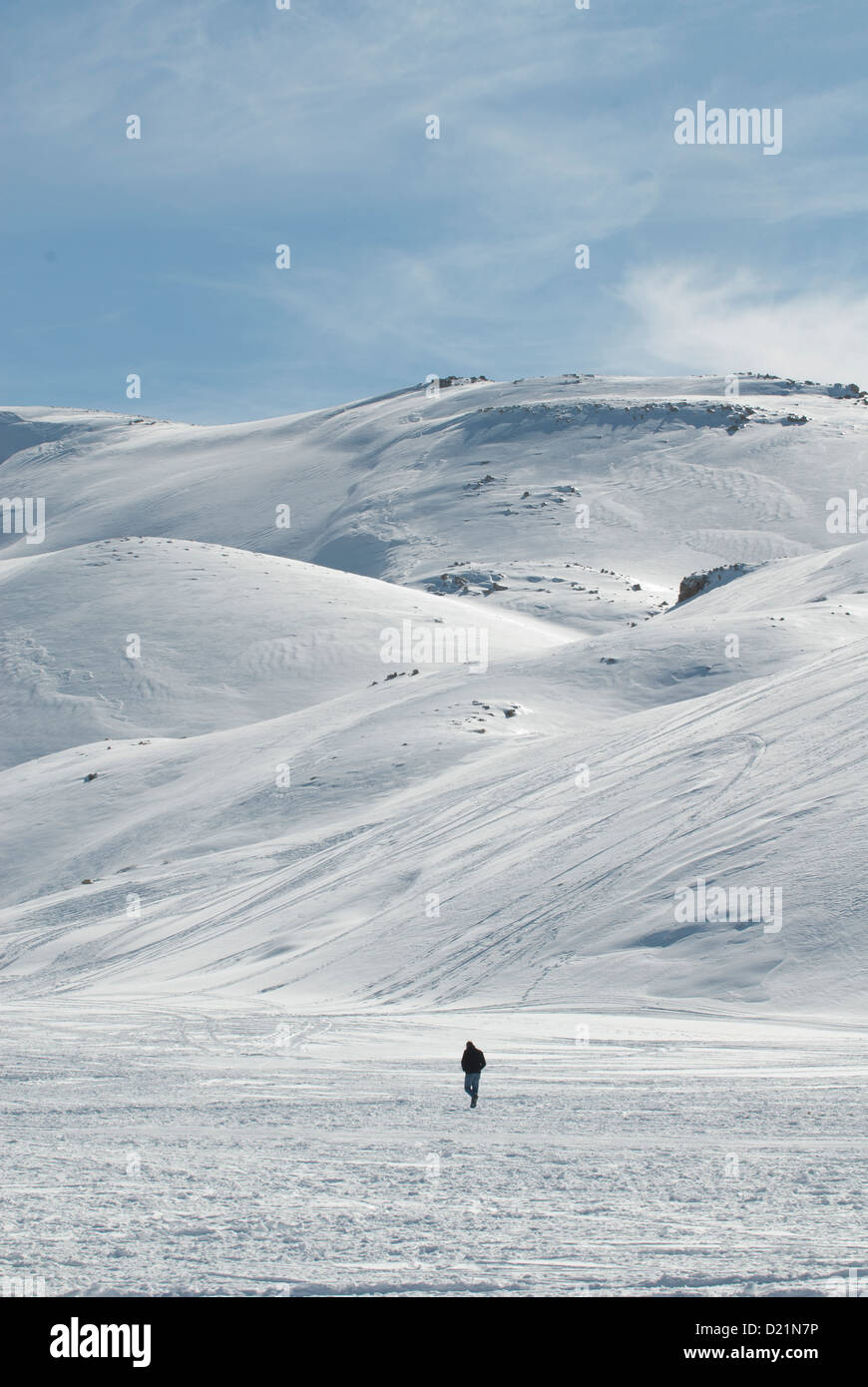Man walking alone in the snow Stock Photo - Alamy