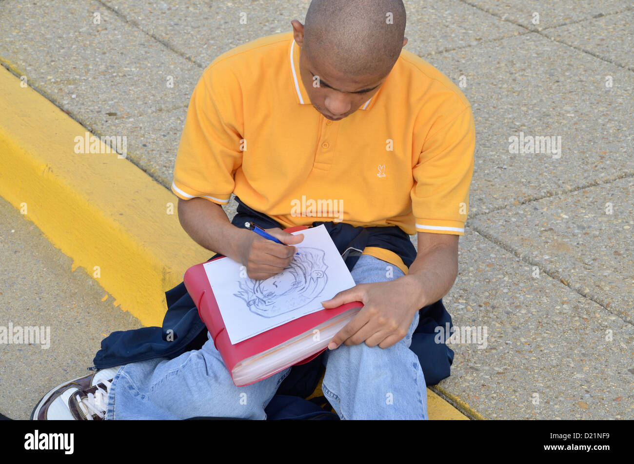 teenage artist drawing a picture sitting on a curb Stock Photo - Alamy